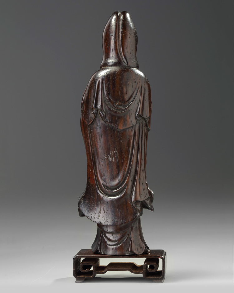 A Chinese hongmu carving of Guanyin and stand