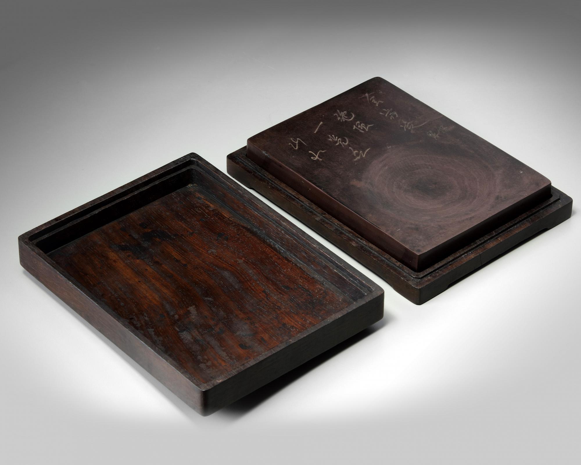 A Chinese ink stone in a wooden box