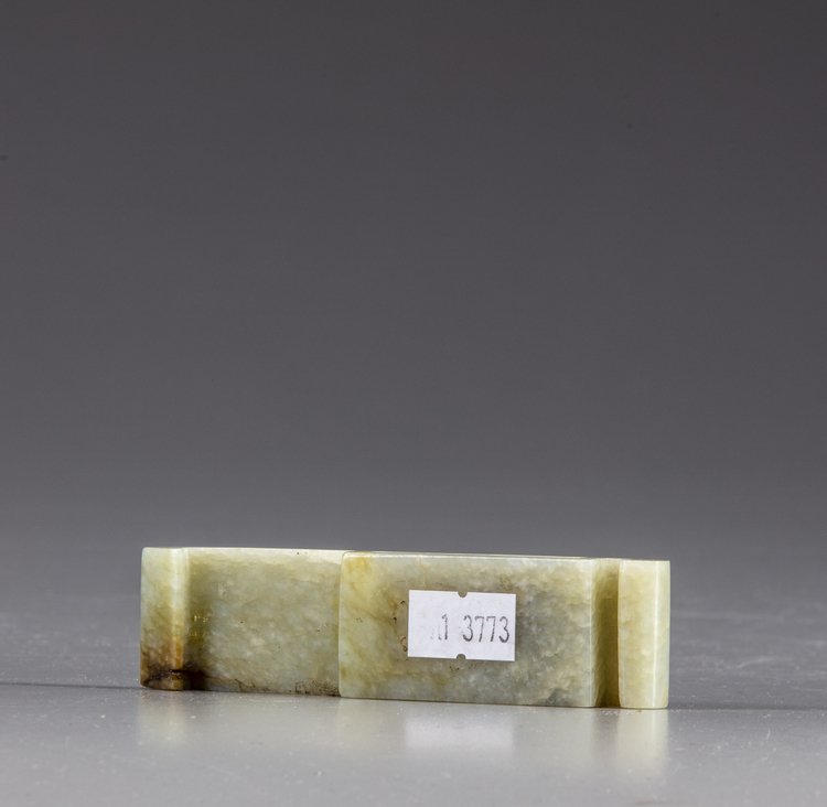 A Chinese celadon jade sword slide