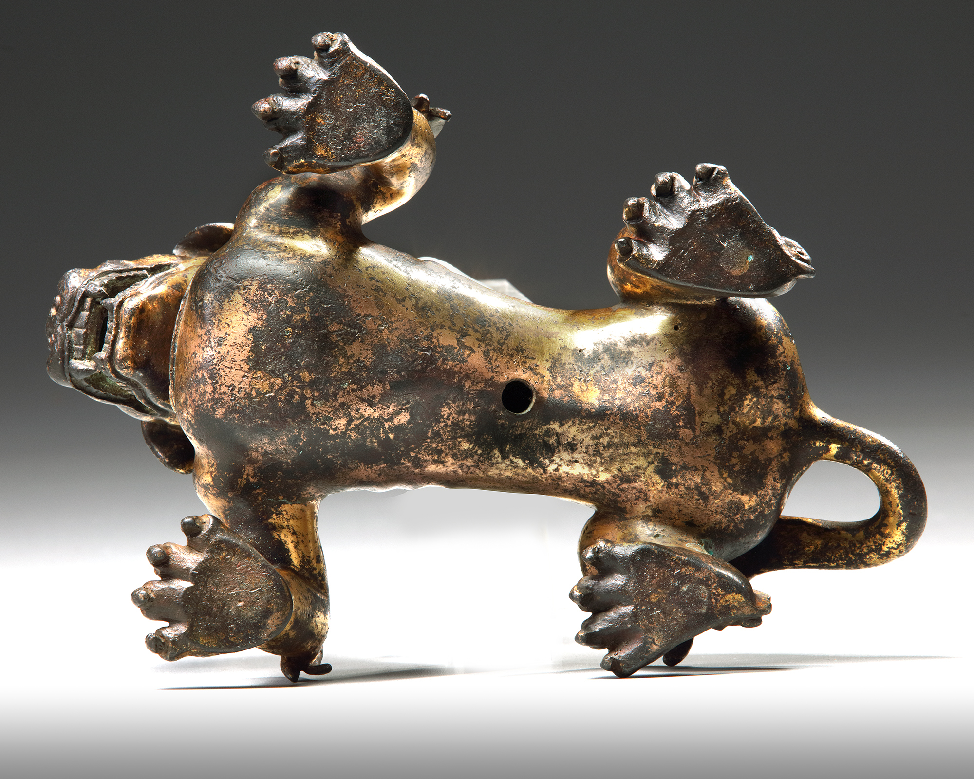 A CHINESE GILT BRONZE FIGURE OF A MYTHICAL BEAST