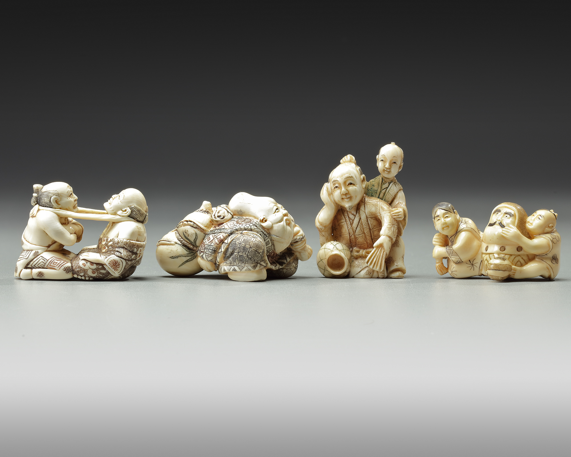A GROUP OF FOUR JAPANESE IVORY NETSUKES, 19TH-20TH CENTURY