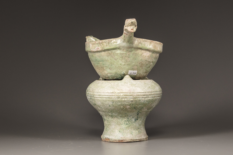 A GREEN-GLAZED RED POTTERY MODEL OF A YI, A LADLE AND BRAZIER, HAN ...