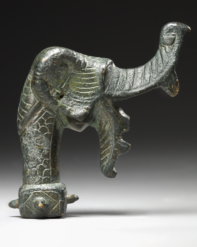 A BRONZE ELEPHANT SPOUT TERMINAL, PERSIA OR CENTRAL ASIA, 11TH-12TH CENTURY