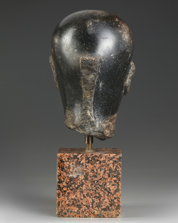 AN EGYPTIAN DIORITE HEAD OF AN OFFICIAL, LATE PERIOD, 30TH DYNASTY, 380 ...