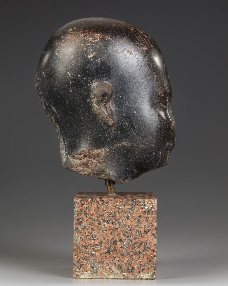 AN EGYPTIAN DIORITE HEAD OF AN OFFICIAL, LATE PERIOD, 30TH DYNASTY, 380 ...
