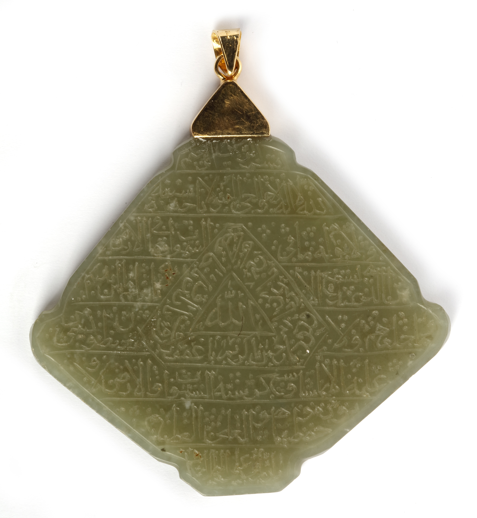 A JADE CARVED TALISMANIC PENDANT