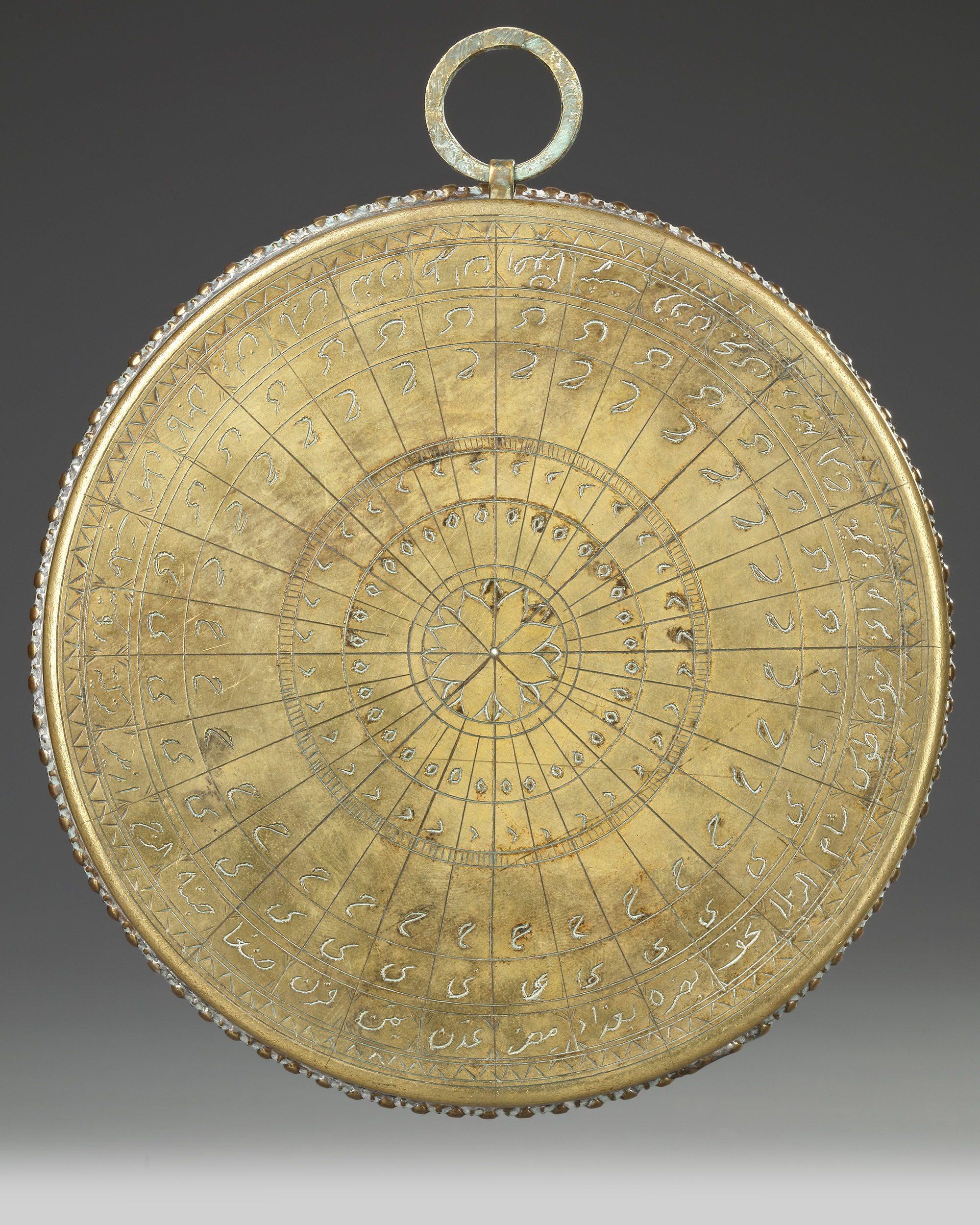 A QAJAR BRASS QIBLA INDICATOR, 19TH CENTURY