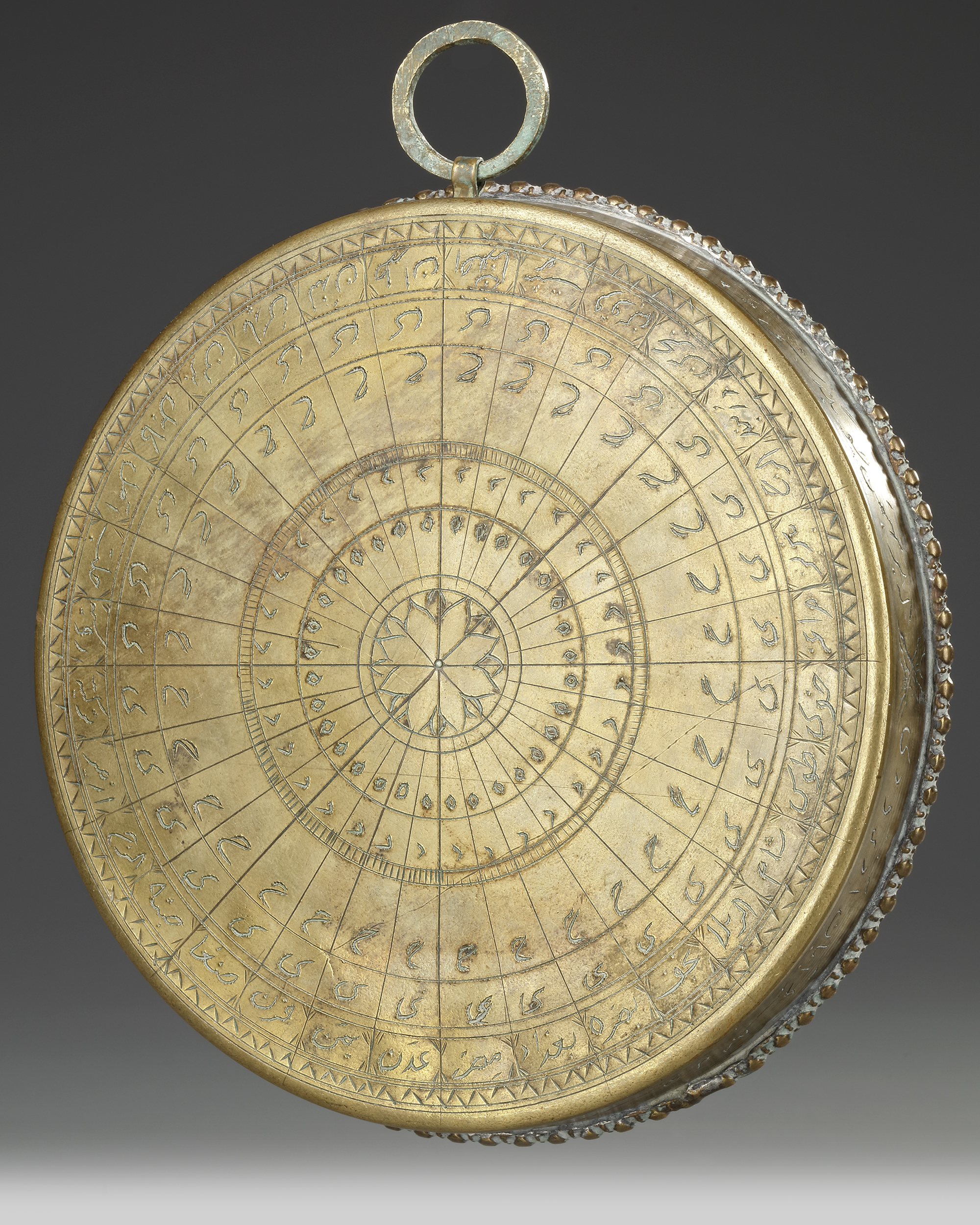 A QAJAR BRASS QIBLA INDICATOR, 19TH CENTURY