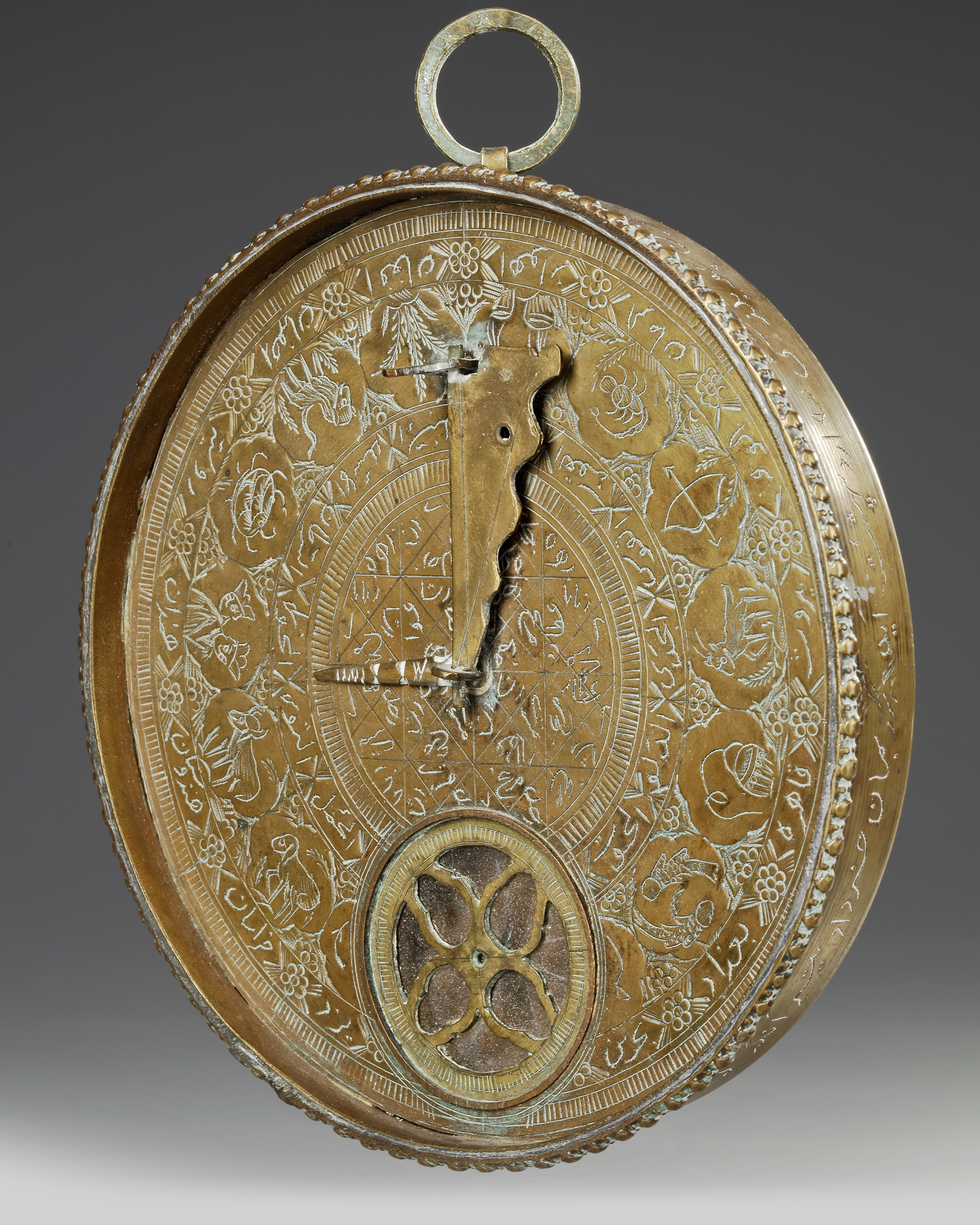 A QAJAR BRASS QIBLA INDICATOR, 19TH CENTURY