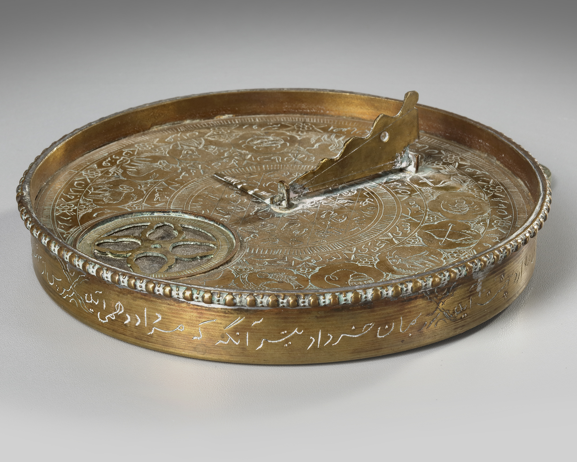 A QAJAR BRASS QIBLA INDICATOR, 19TH CENTURY