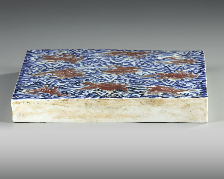 A CHINESE UNDERGLAZE COPPER RED AND BLUE TILE, QING DYNASTY (1644-1911)