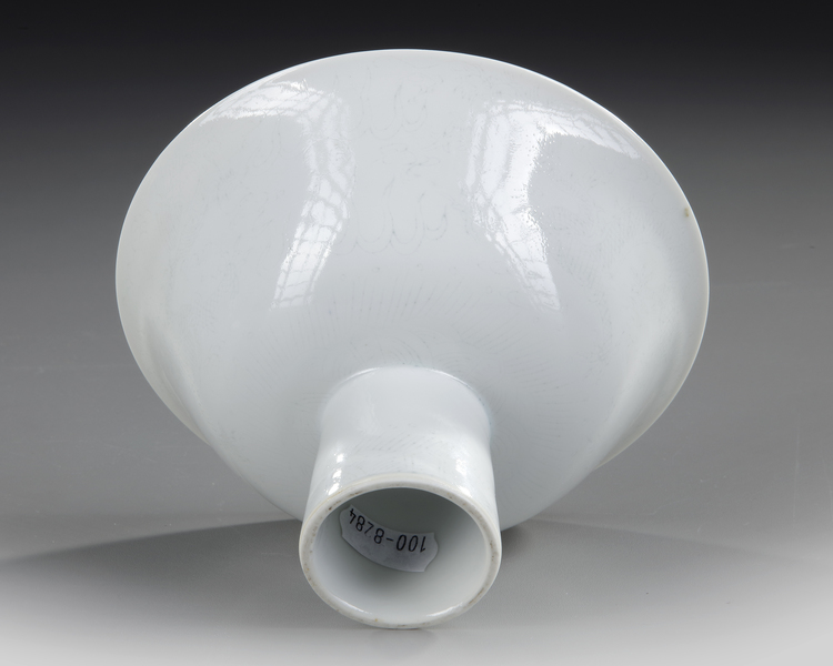 A CHINESE WHITE-GLAZED ANHUA DRAGON STEM CUP, EARLY 18TH CENTURY