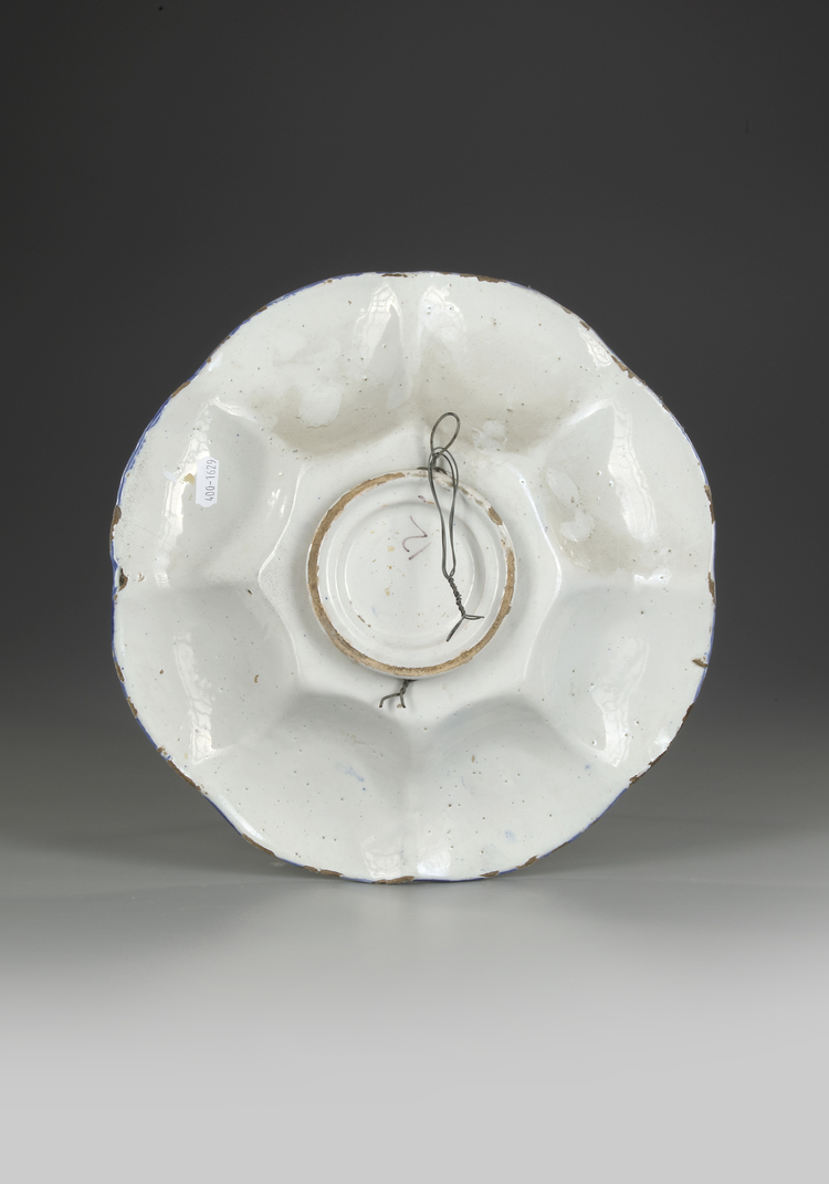 A LOBBED FAIENCE CHARGER, DELFT OR GERMANY, LATE 17TH CENTURY