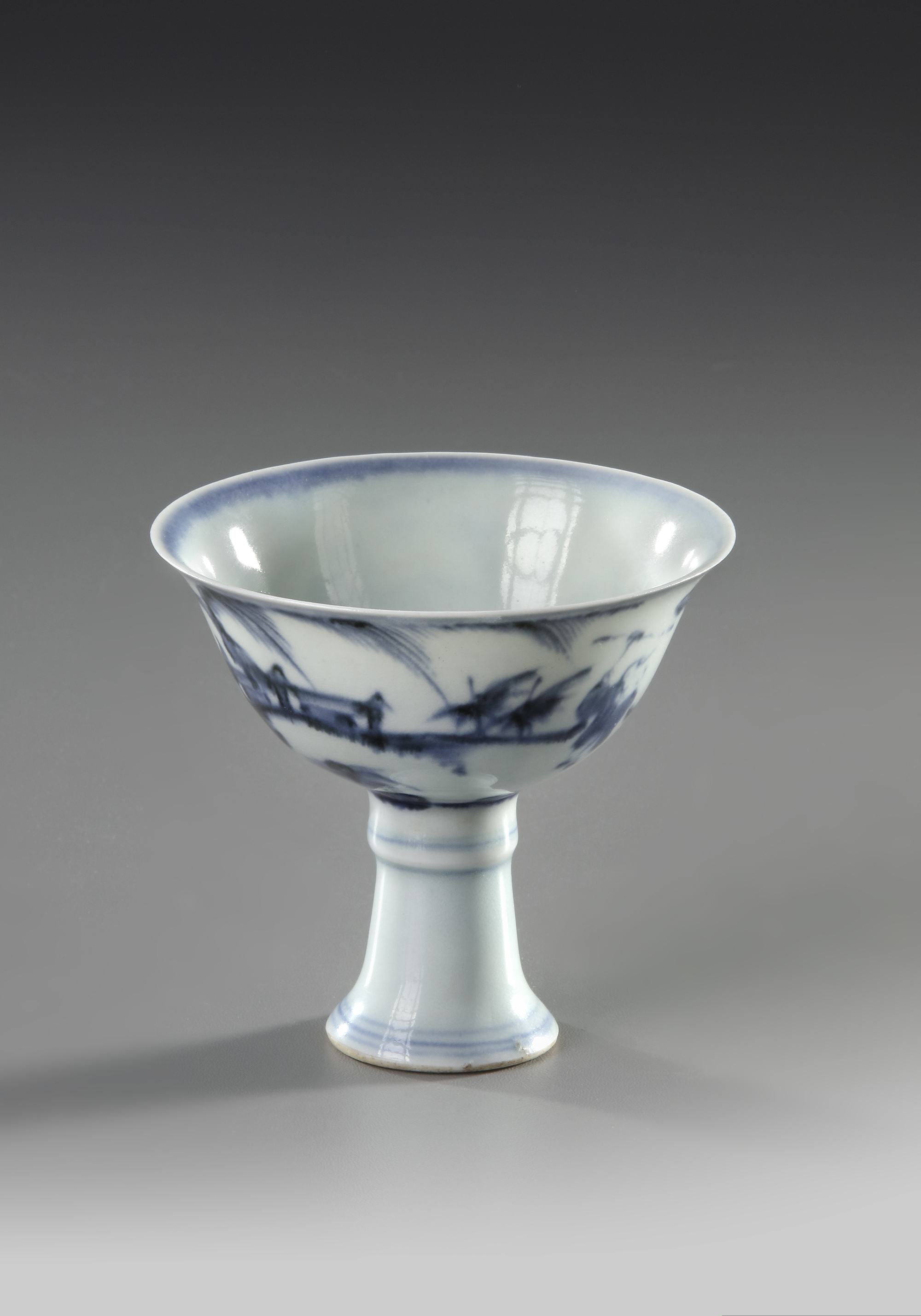 A CHINESE BLUE AND WHITE BOYS STEM CUP