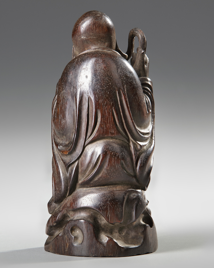 A CHINESE WOOD CARVING OF A LOHAN, 20TH CENTURY