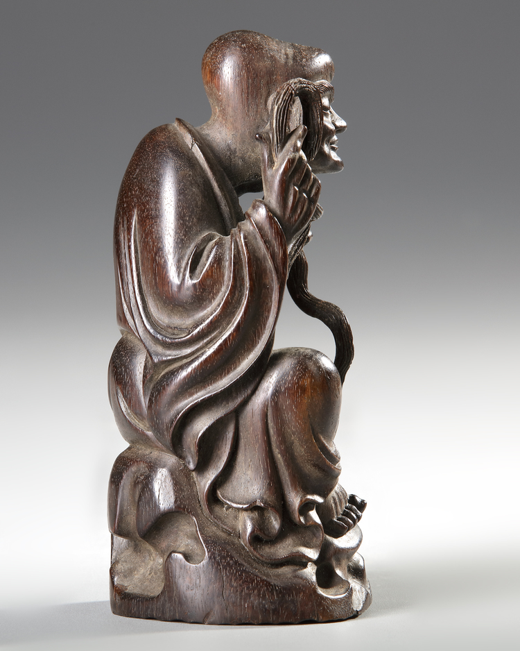 A CHINESE WOOD CARVING OF A LOHAN, 20TH CENTURY