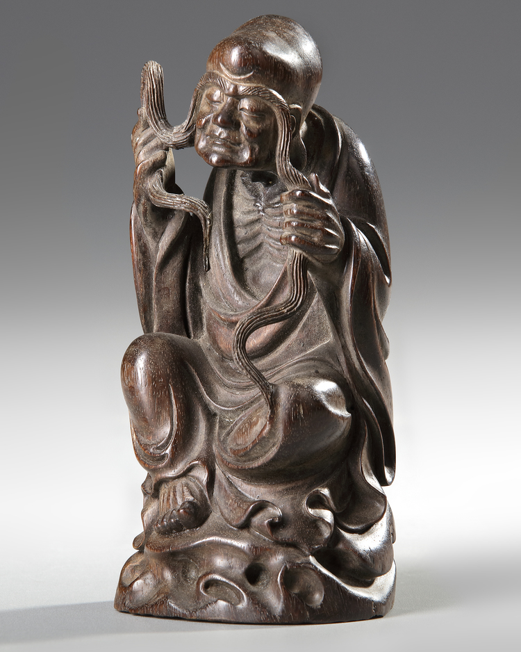 A CHINESE WOOD CARVING OF A LOHAN, 20TH CENTURY