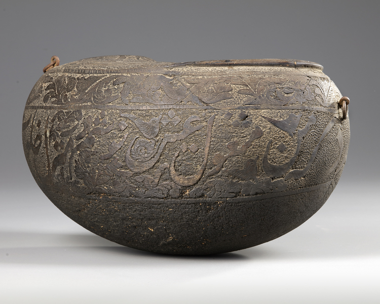 A LARGE QAJAR WOODEN BEGGAR'S BOWL (KASHKUL), 19TH CENTURY