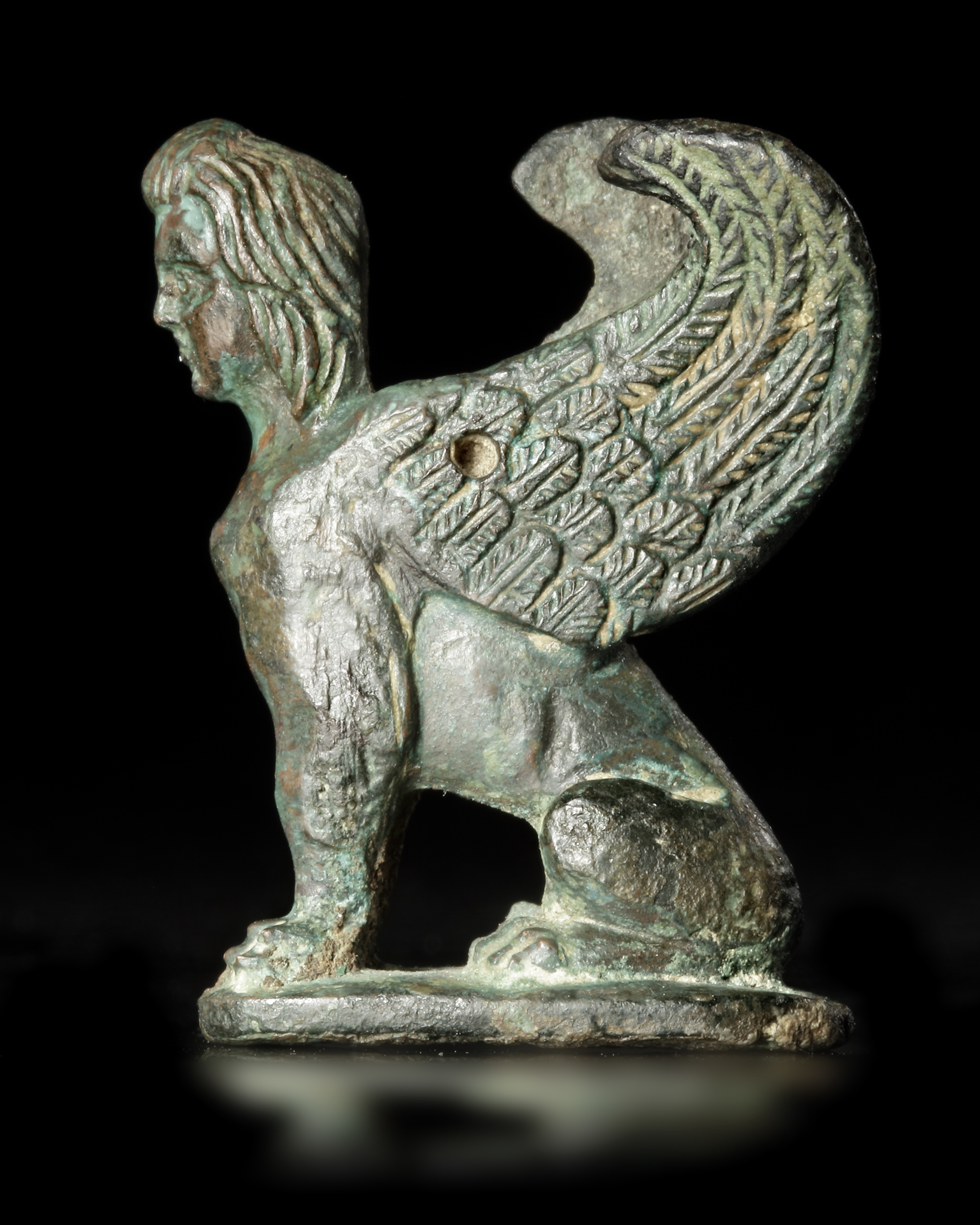 A SEATED BRONZE SPHINX, HELLENISTIC, 1ST-2ND CENTURY BC