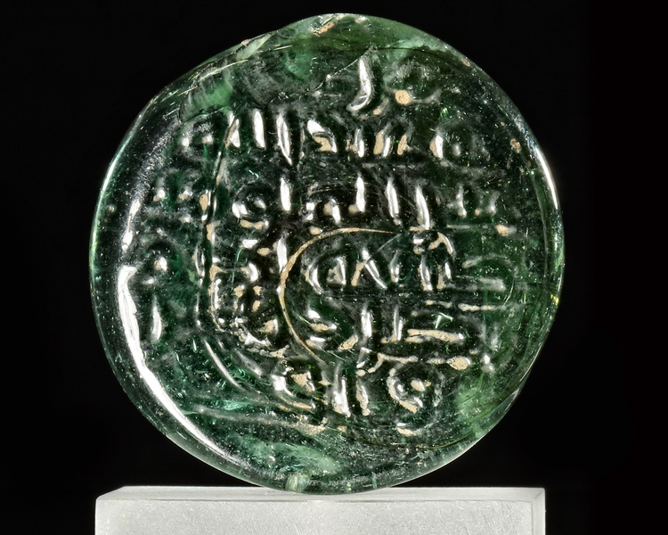 * AN ISLAMIC GREEN GLASS LEAD SEAL ( BULLA), 9TH-10TH CENTURY