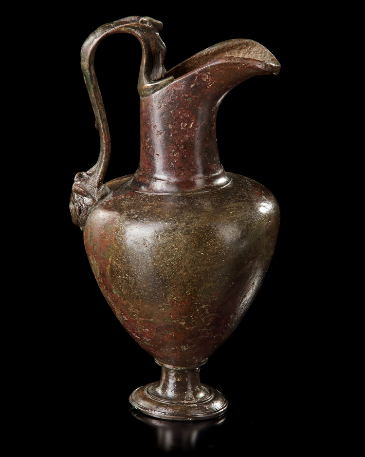 A ROMAN BEAKED JUG WITH FIGURAL HANDLE, CIRCA 1ST CENTURY AD
