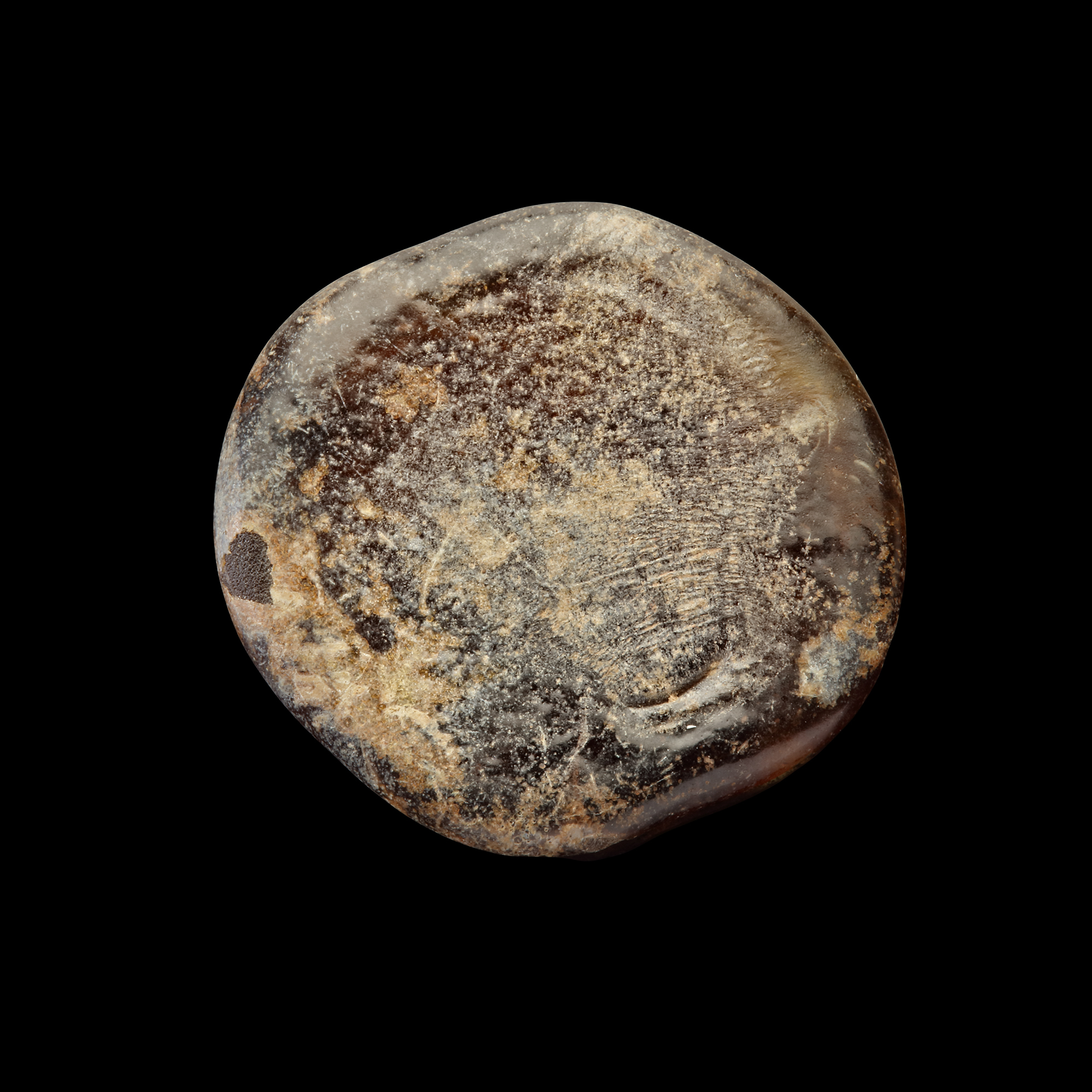 AN EARLY ISLAMIC GLASS WEIGHT OF DINAR