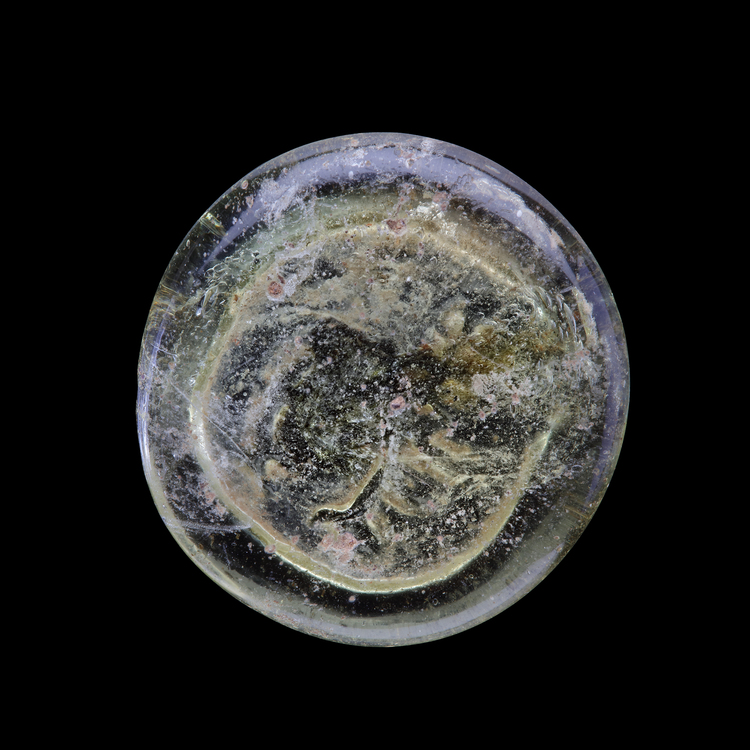 AN EARLY ISLAMIC GLASS WEIGHT OF DINAR, 10TH-11TH CENTURY