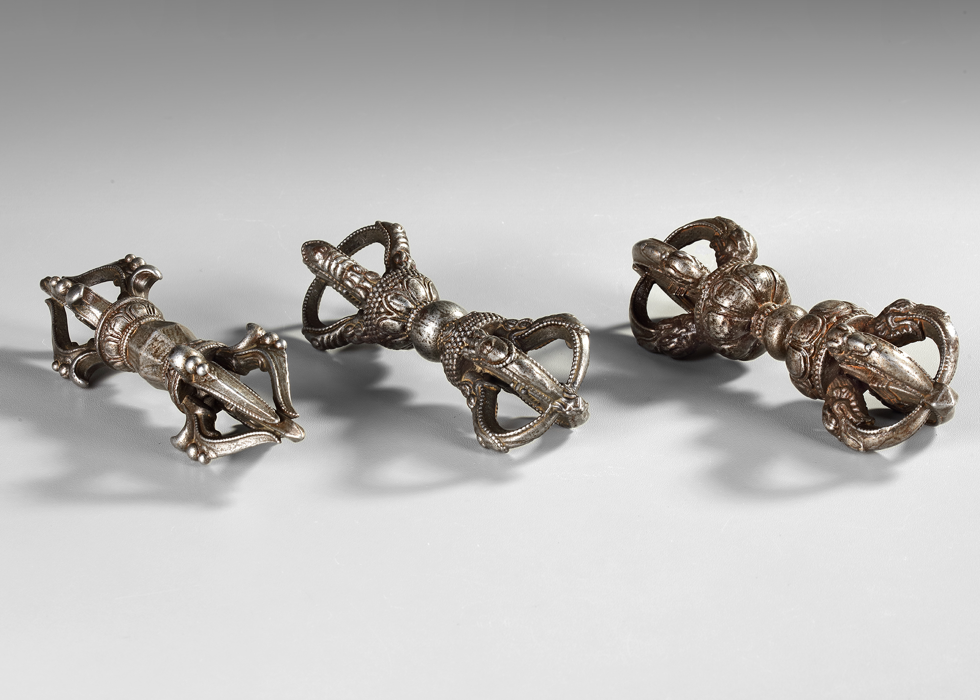 A GROUP OF THREE SINO-TIBETAN BRONZE VAJRAS, 19TH CENTURY