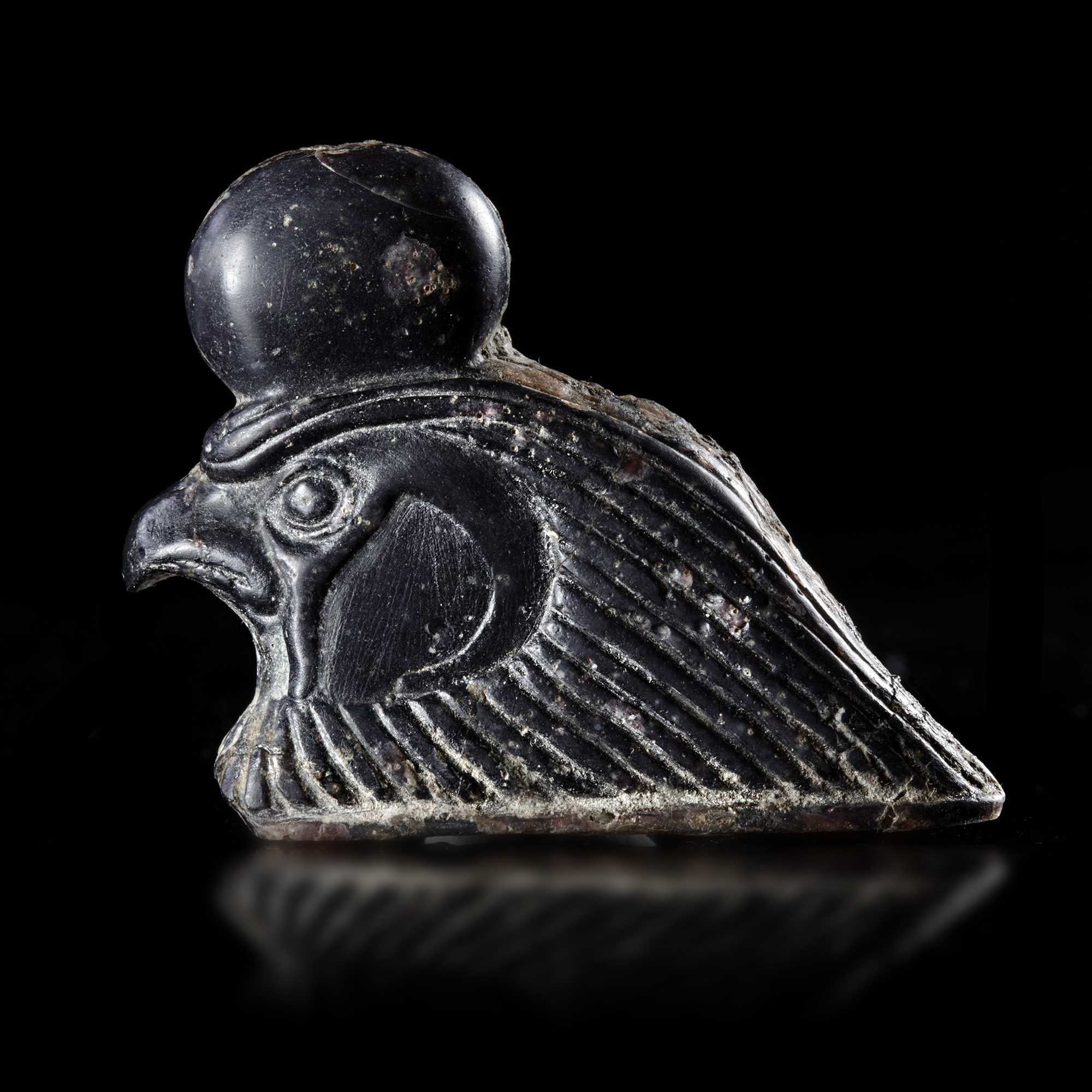 A HEAD OF HORUS IN PROFILE IN BLACK SERPENTINE, LATE PERIOD, 4TH-5TH ...
