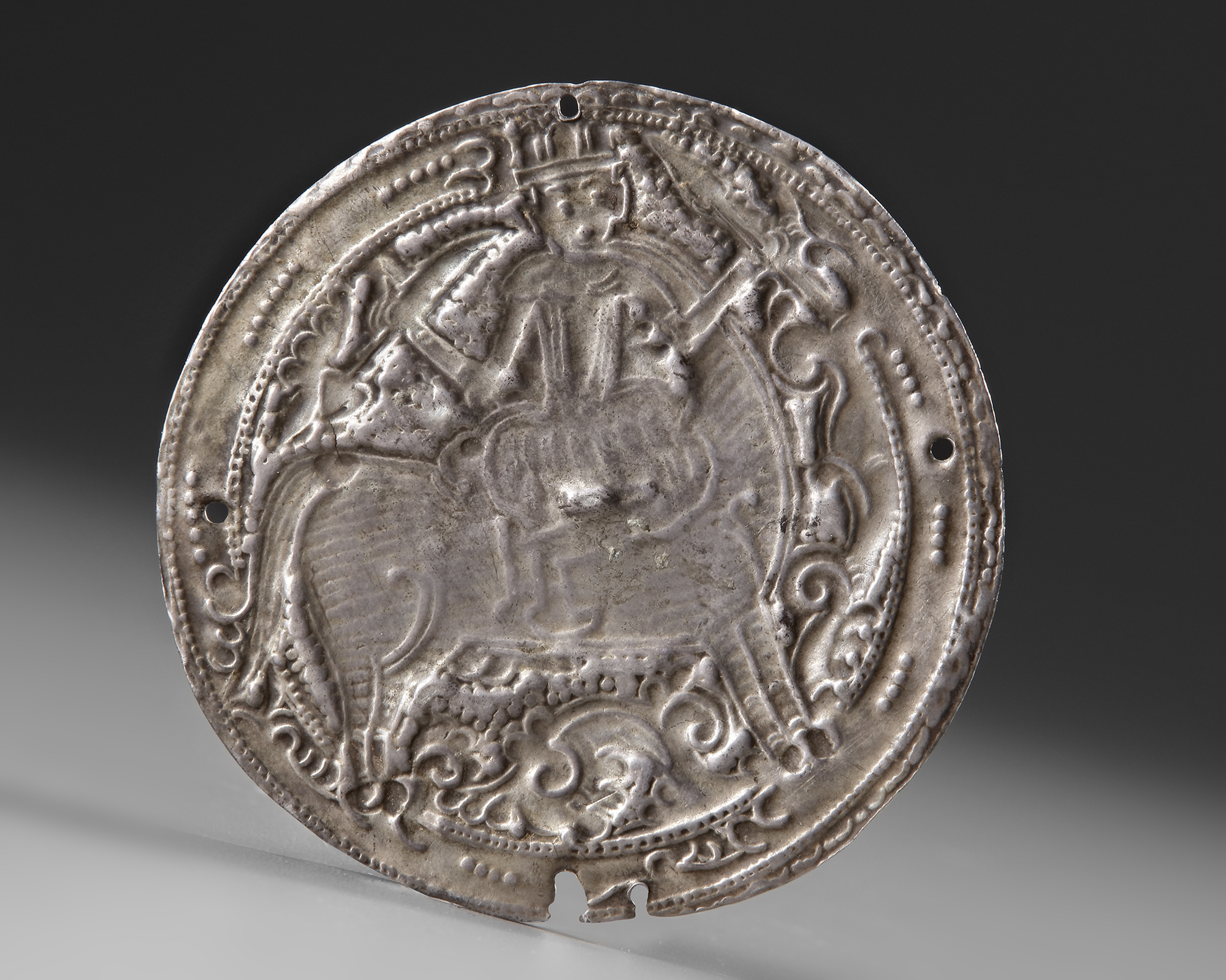 A SILVER SELJUK CIRCULAR PLAQUE, POSSIBLY A MIRROR, 12TH-13TH CENTURY