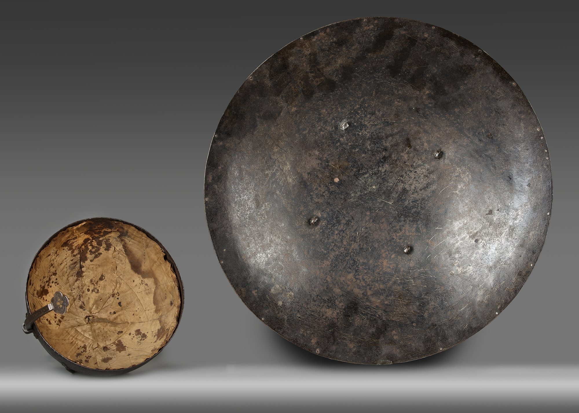 A QAJAR WATERED-STEEL HELMET AND SHIELD, PERSIA 19TH CENTURY
