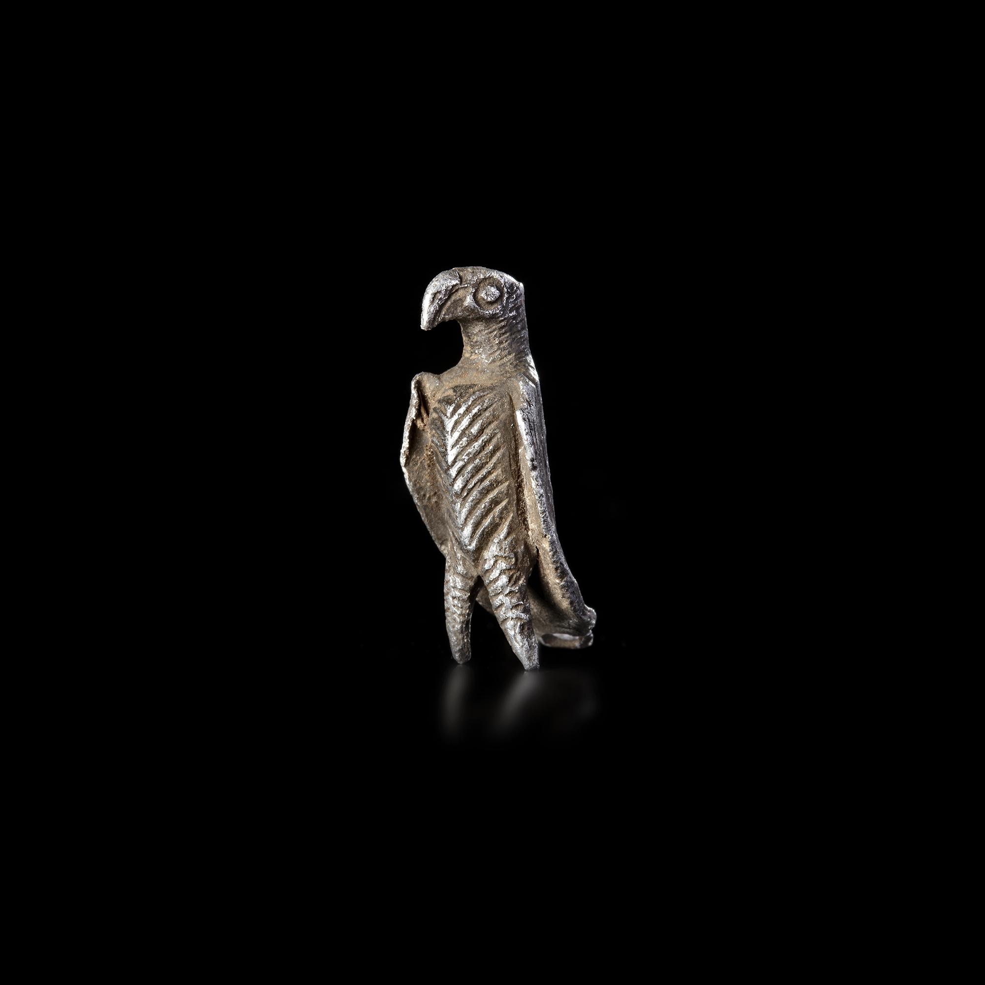 A SILVER STATUETTE OF AN EAGLE/FALCON, 3RD CENTURY BC