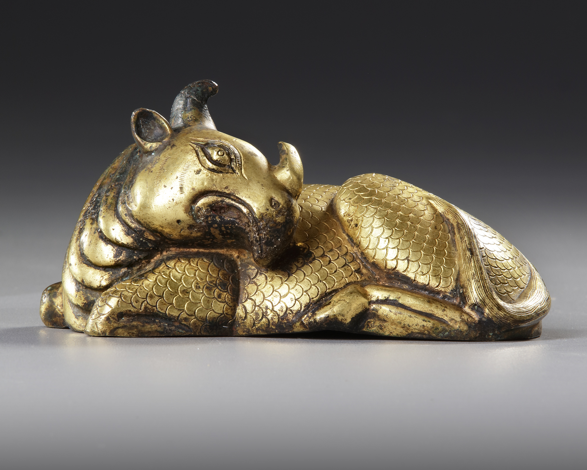 A GILT CHINESE BRONZE 'MYTHICAL BEAST ' WEIGHT, MING DYNASTY OR LATER