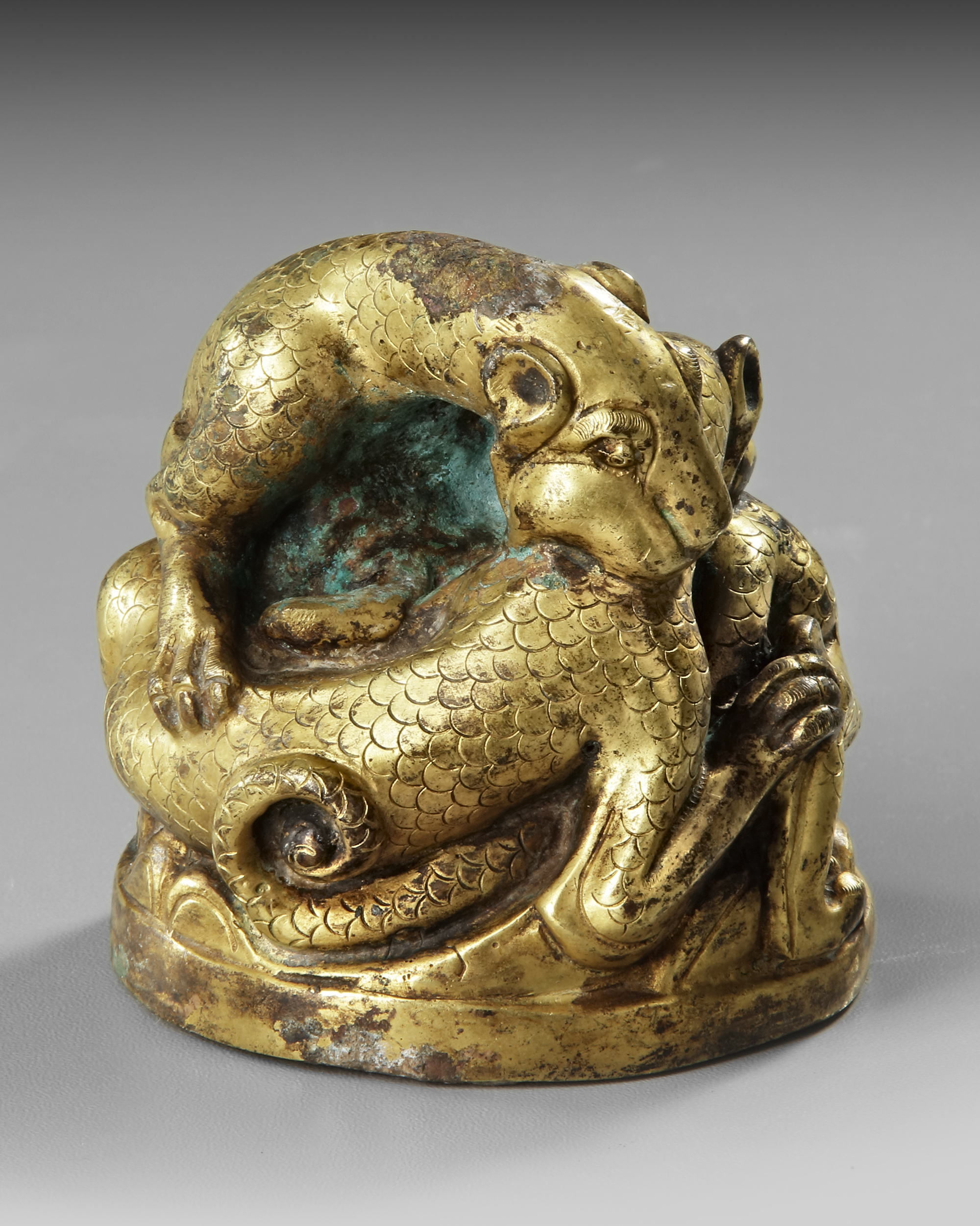 A GILT CHINESE BRONZE TWIN-CHILONG WEIGHT, MING DYNASTY OR LATER