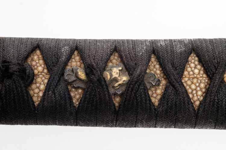 A short Japanese sword (wakizashi) with a black lacquered scabbard ...