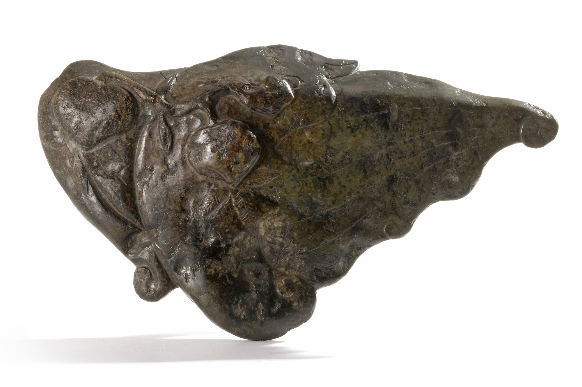 A large Chinese celadon and grey jade 'bat and peaches' carving